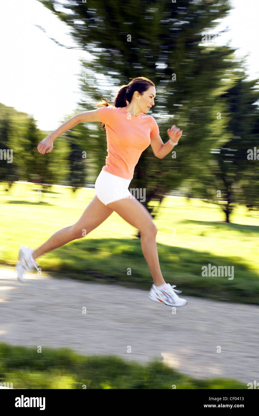 Female very long brunette hair tied into ponytail, wearing an orange t ...