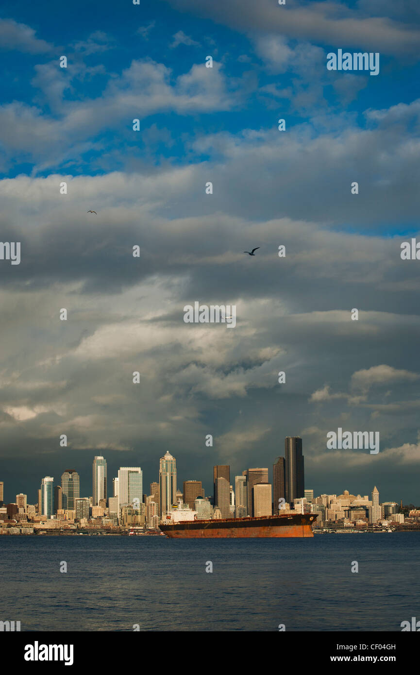 A dramatic sunset highlights the beautiful Seattle waterfront across ...