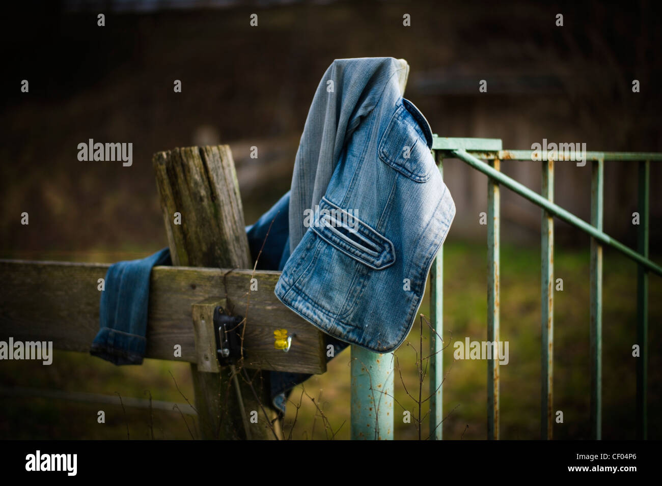 Blue denim jacket hanging on a gate Stock Photo - Alamy
