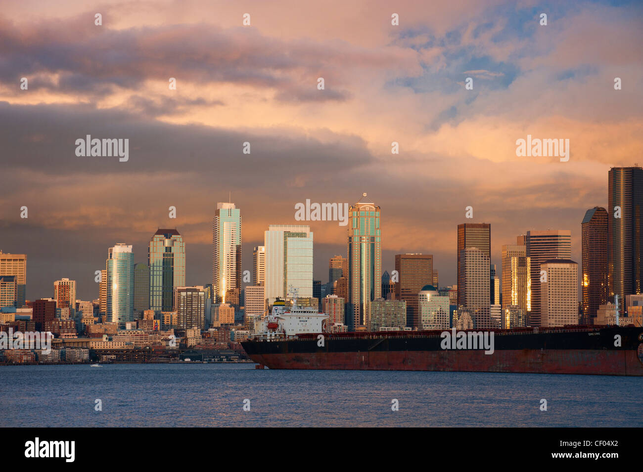 A dramatic sunset highlights the beautiful Seattle waterfront across ...