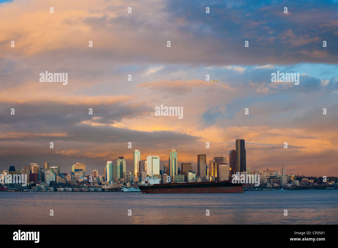 A dramatic sunset highlights the beautiful Seattle waterfront across ...
