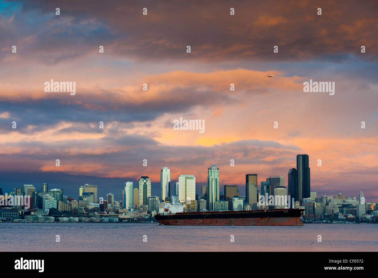 A dramatic sunset highlights the beautiful Seattle waterfront across ...