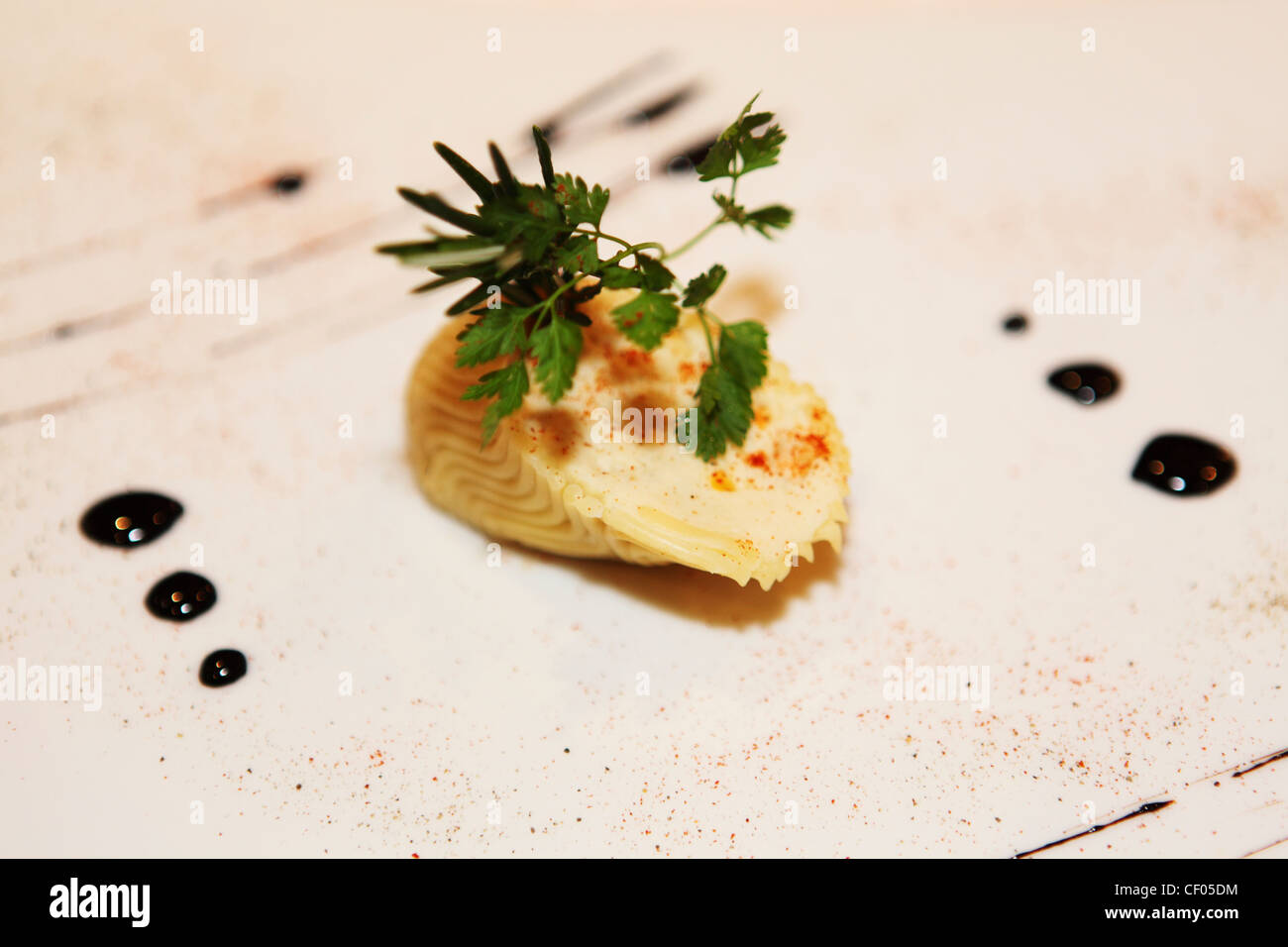 A mouselline of fish is served with a balsamic reduction Stock Photo ...