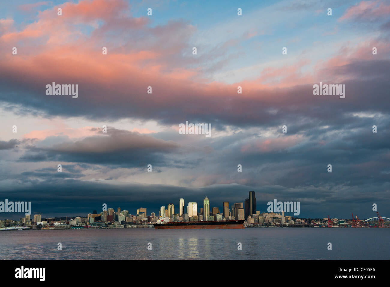 A dramatic sunset highlights the beautiful Seattle waterfront across ...