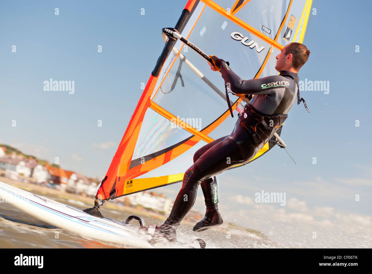 a windsurfer close up as he surfs towards land and the shore Stock ...