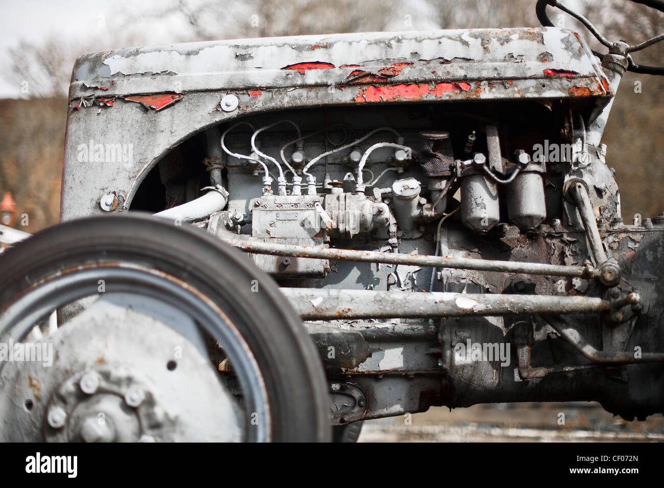 the engine of an old abandoned tractor with flaking paint Stock Photo ...
