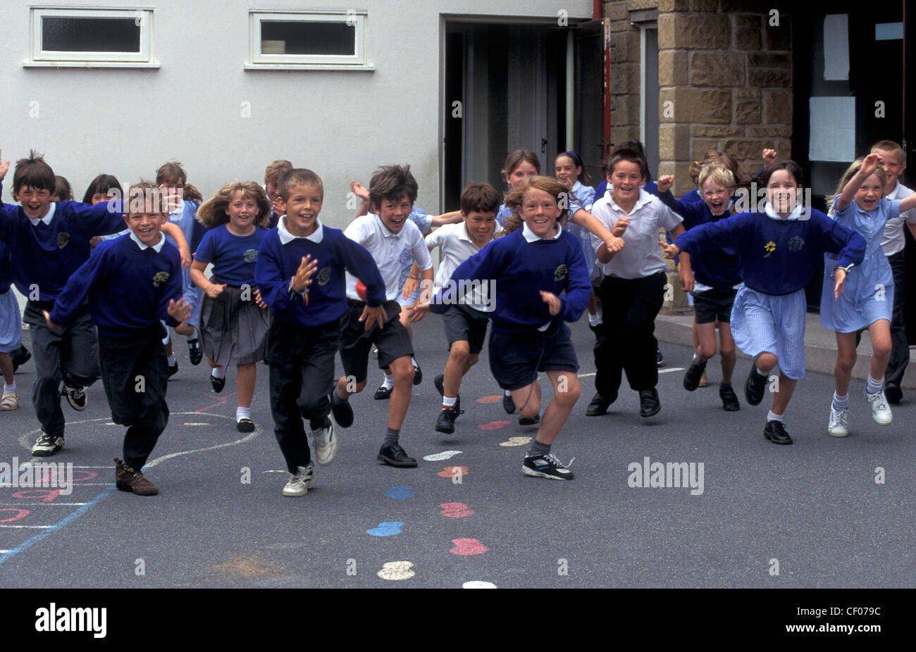 primary school kids running excitedly into playground Stock Photo - Alamy