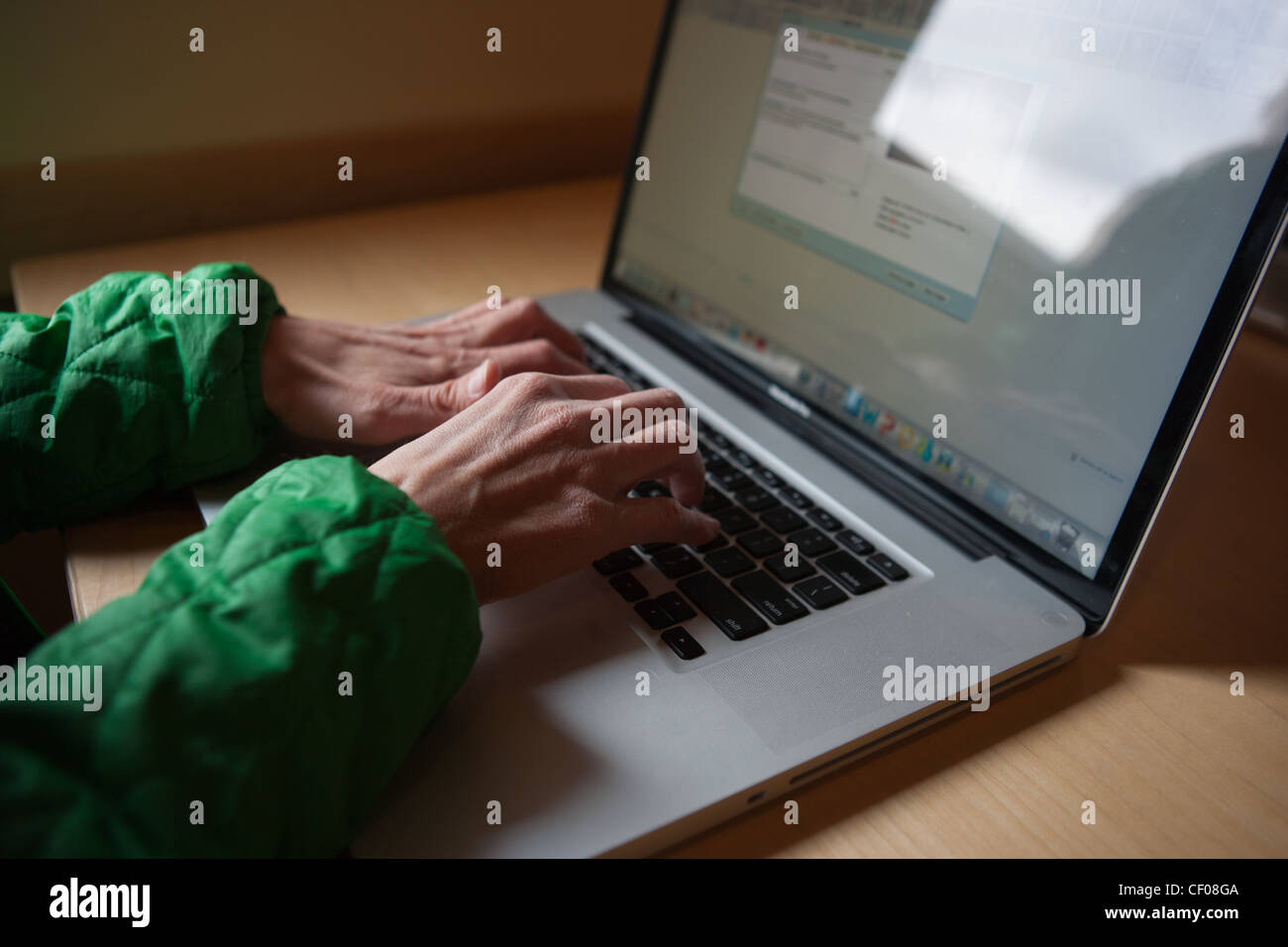 Close up of forty year old woman typing on her lap top keyboard ...