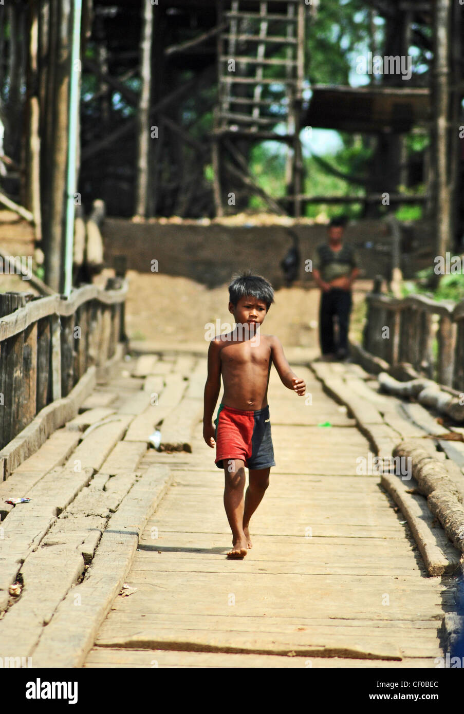 A boy walks over a bridge in Kompong Khleang, Cambodia Stock Photo - Alamy