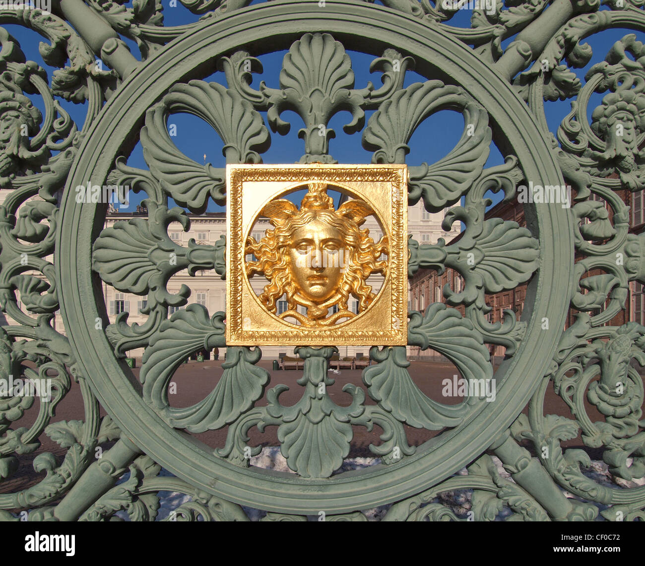 Ancient baroque golden mask on Palazzo Reale (The Royal Palace) fence ...