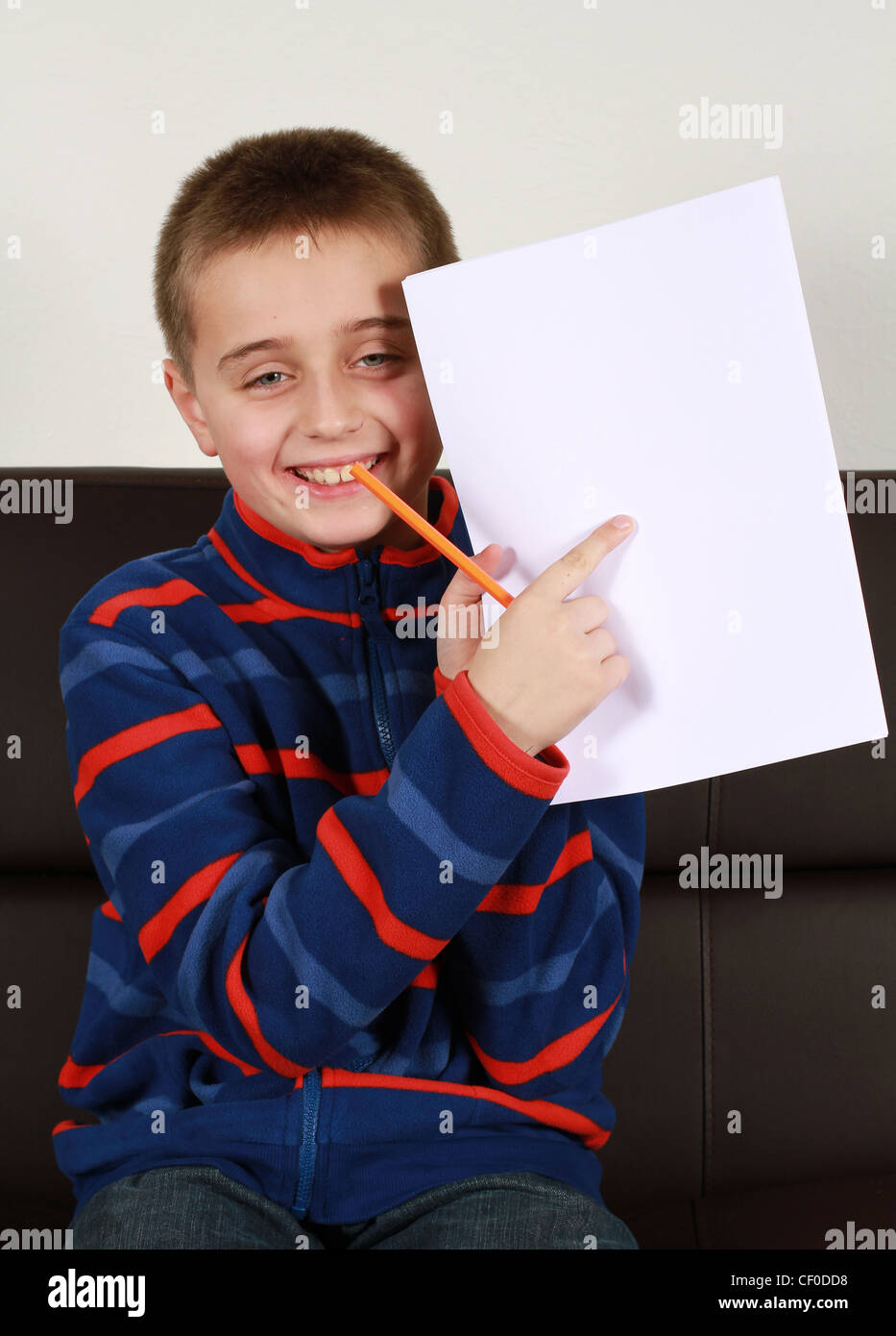 Young boy writes on some blank plan white paper Stock Photo - Alamy