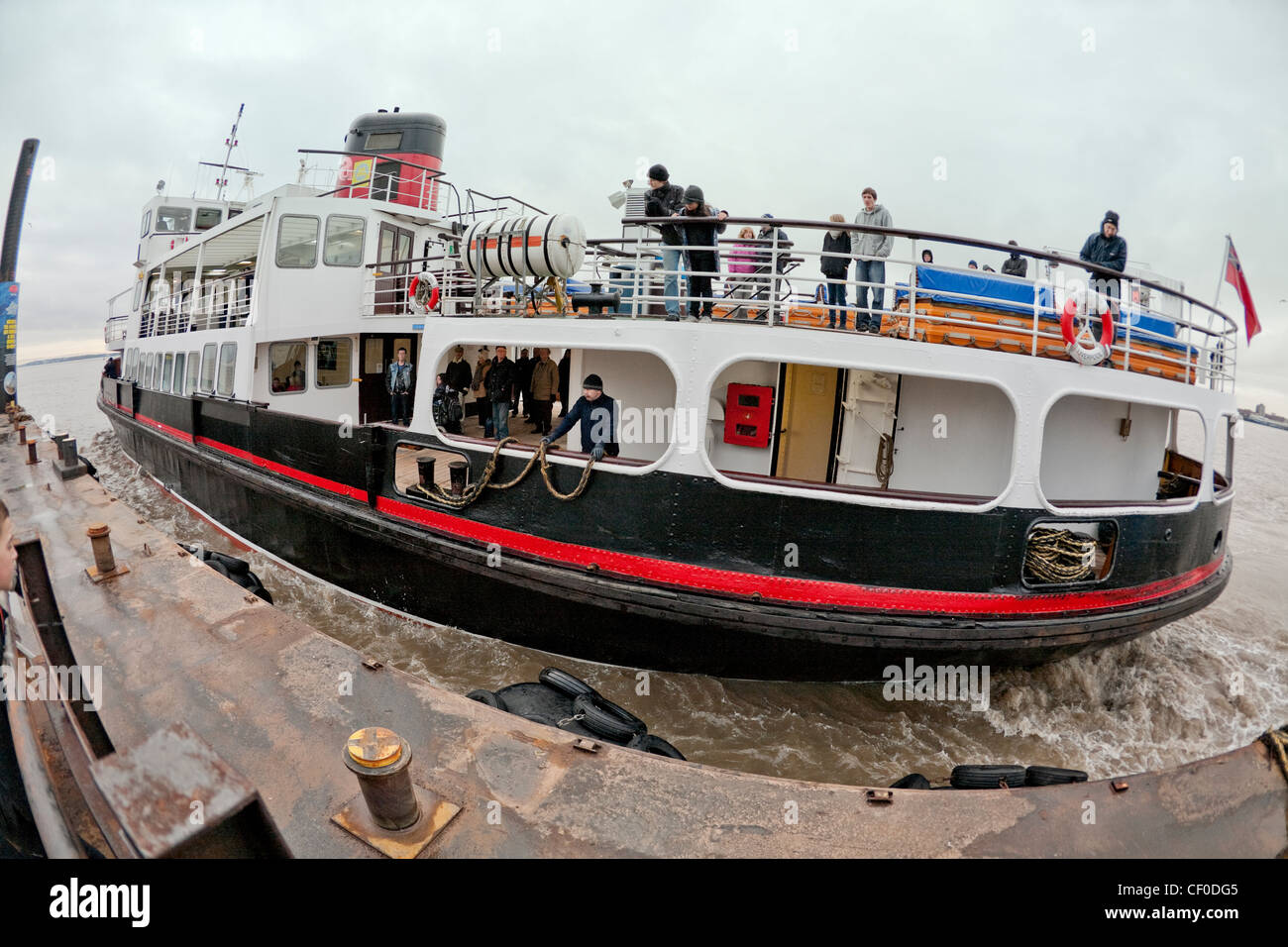 mersey ferry boat arrives at liverpool landing stage with passengers ...