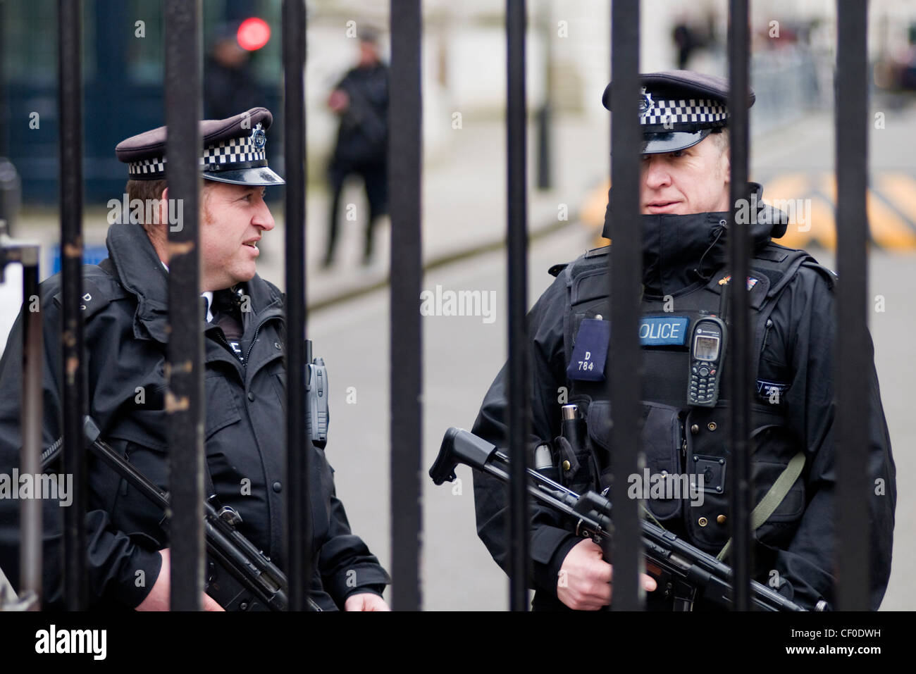 Armed police officers on patrol in Downing Street, London, England, UK ...