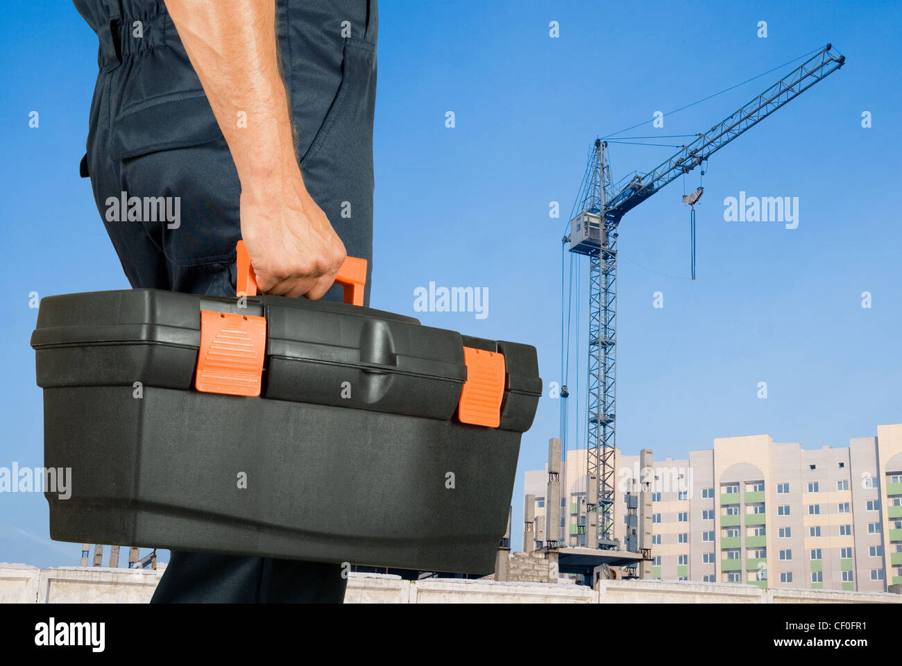 repairman with box of instruments on building background Stock Photo ...