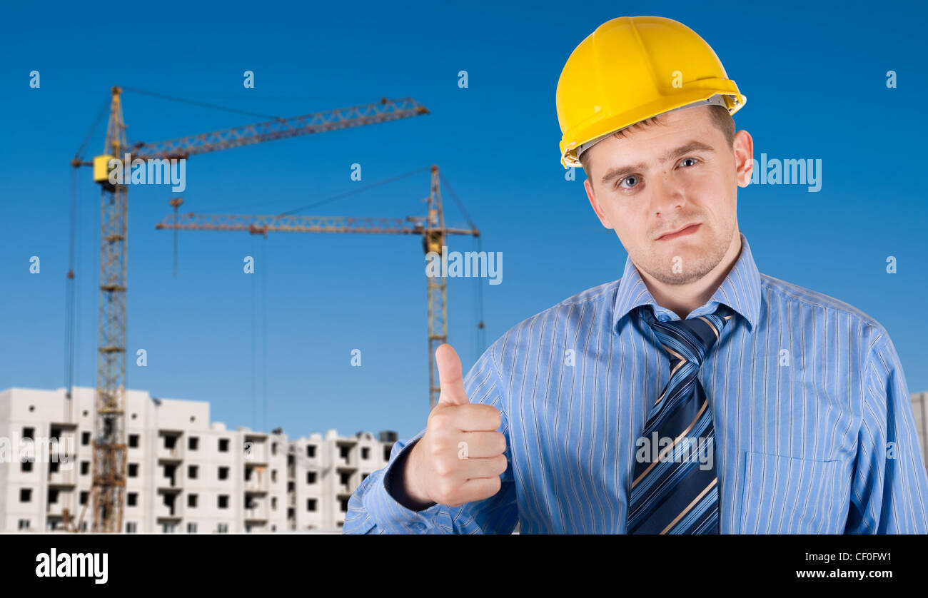 Engineer at white helmet on building background Stock Photo - Alamy