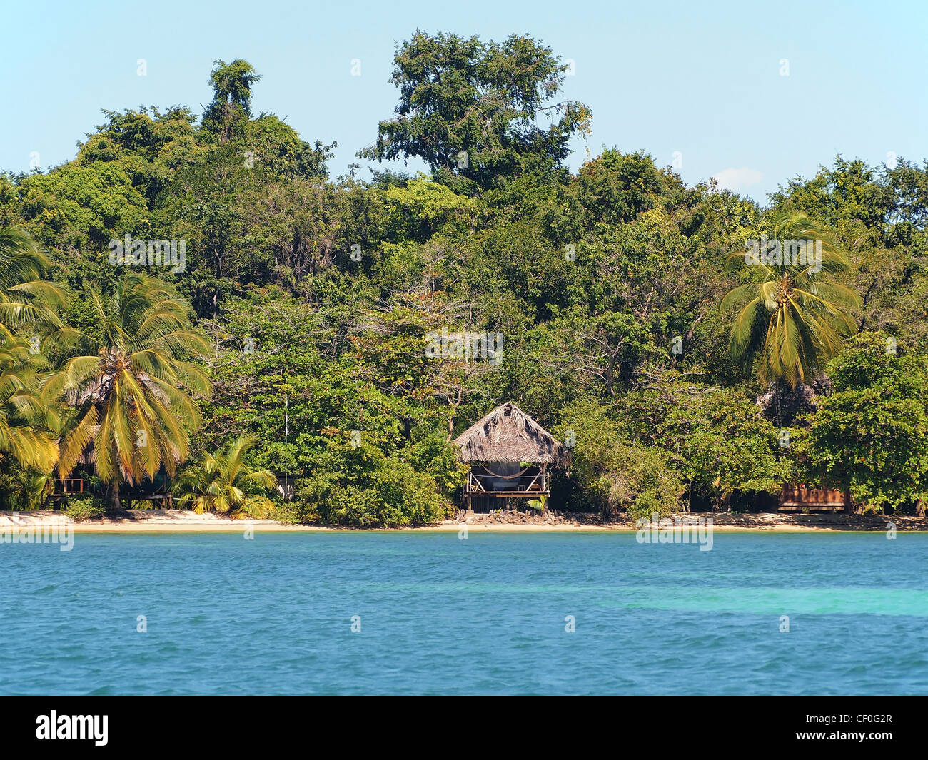 Landscape of tropical island beach with an open-air hut Stock Photo - Alamy