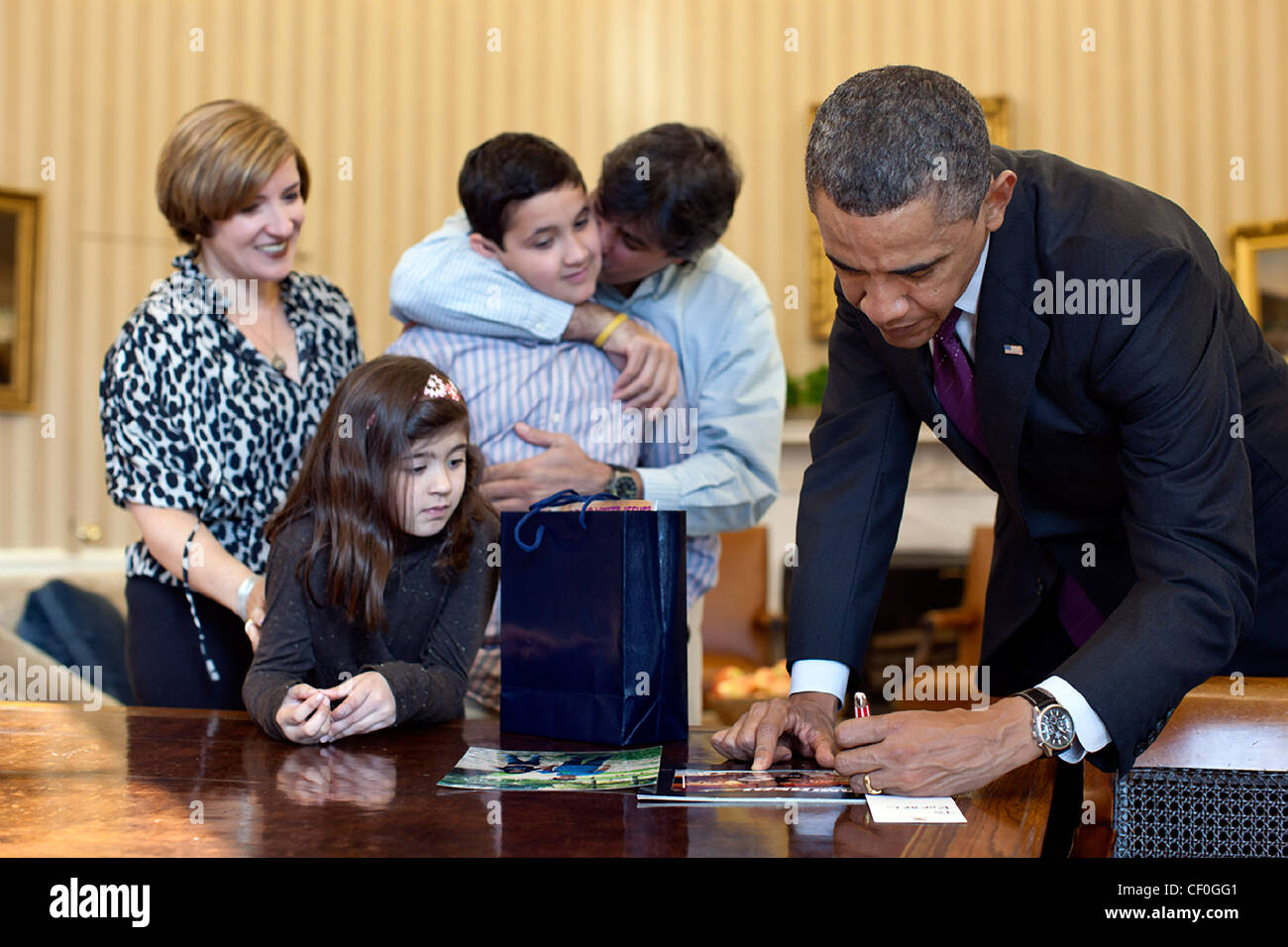 President Barack Obama signs items for Make-A-Wish child Rafael Mullet ...