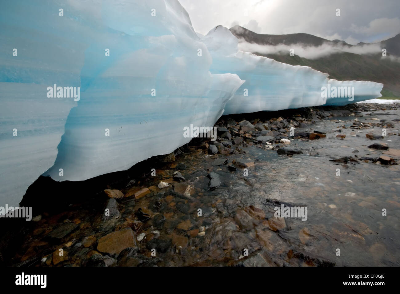 Wild Russia landscape. Ice glacier blocks, stones, Eheger river. Sayan ...