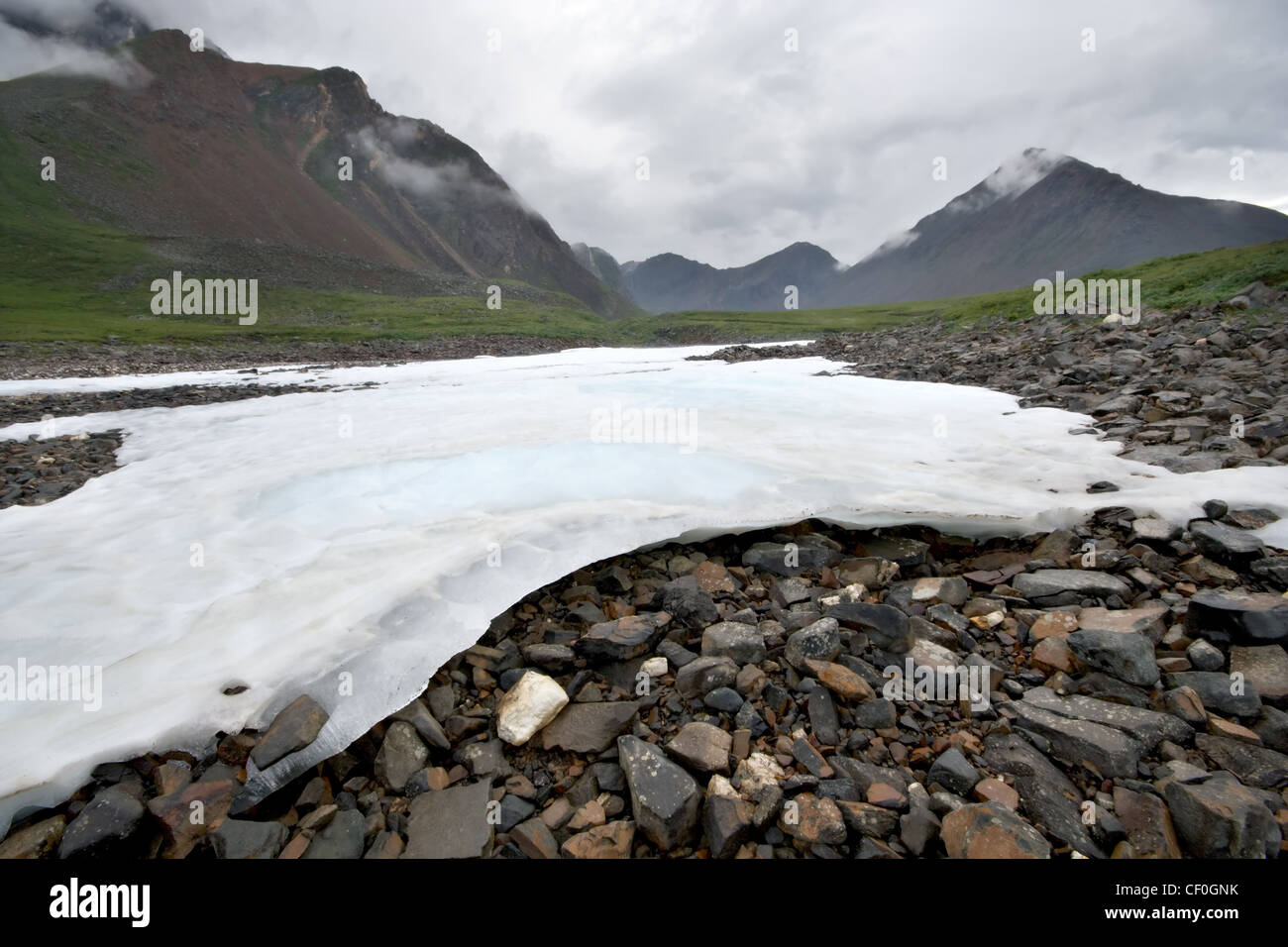 White ice on stones. Eastern Sayan mountains valley. Buryat republic ...