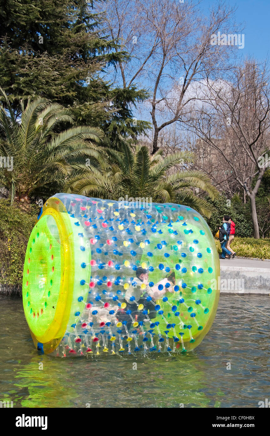 Children playing in a water ball - Fuxing park, french old concession ...