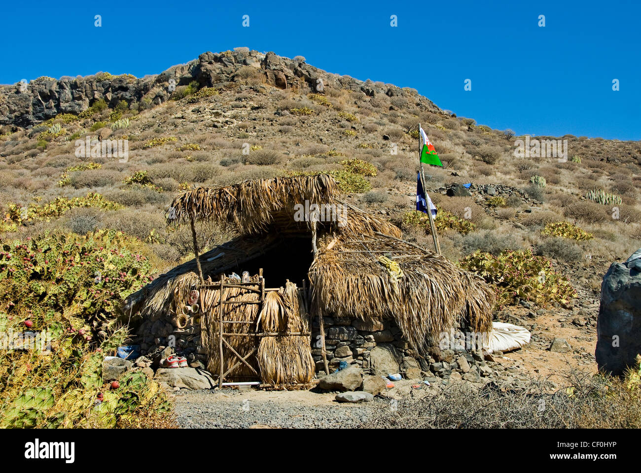 Ramshackle shack built in a quiet cove, close to the beach. camp cave ...