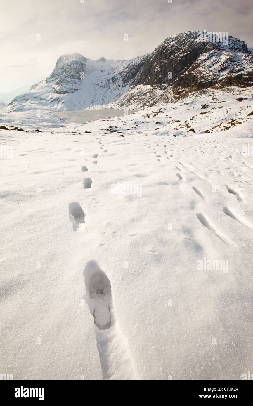 Footsteps in the snow above Stickle Tarn, looking towards Pavey Ark in ...