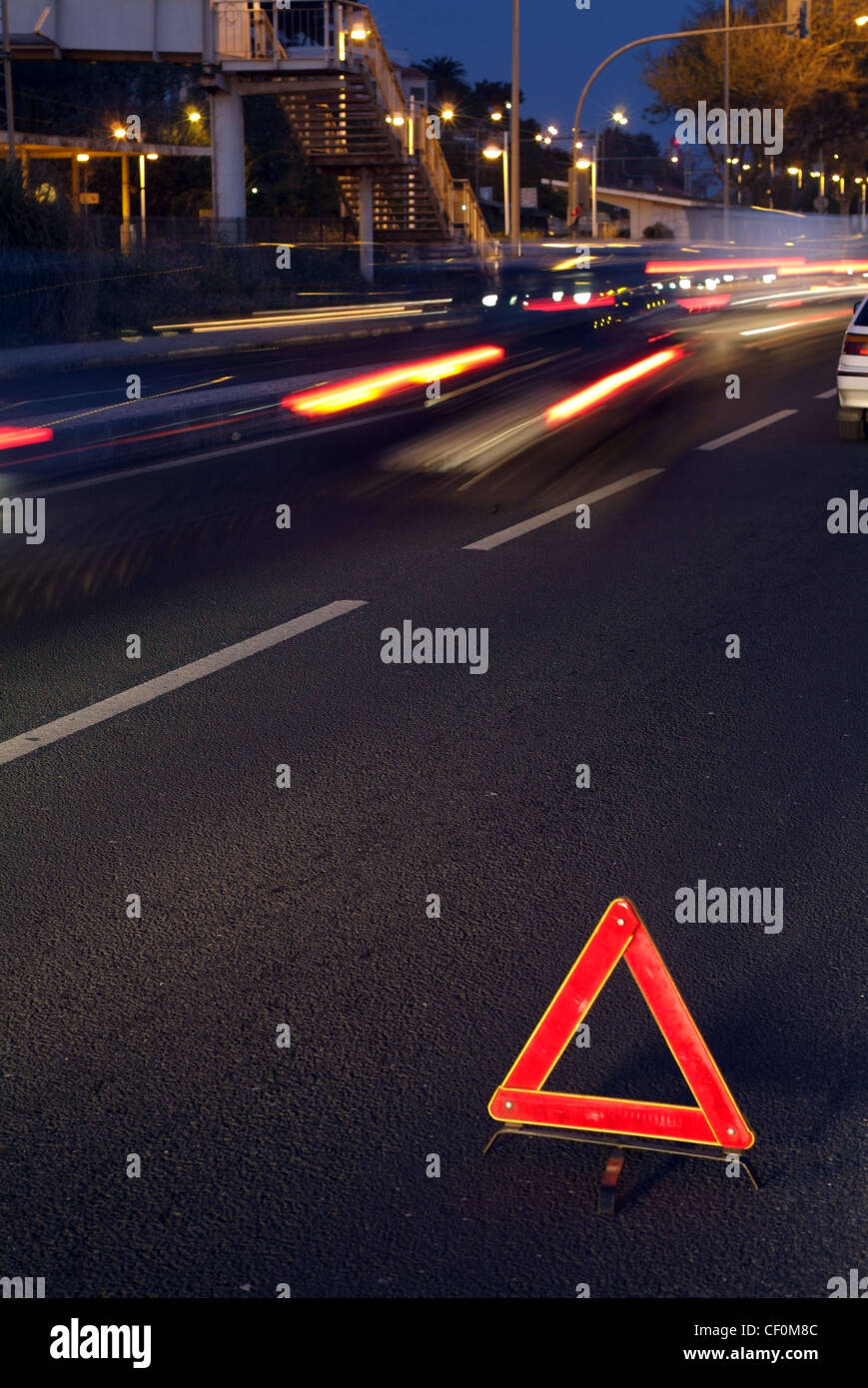 Car Broken Down on Road With Hazard Warning Sign In Foreground Stock ...