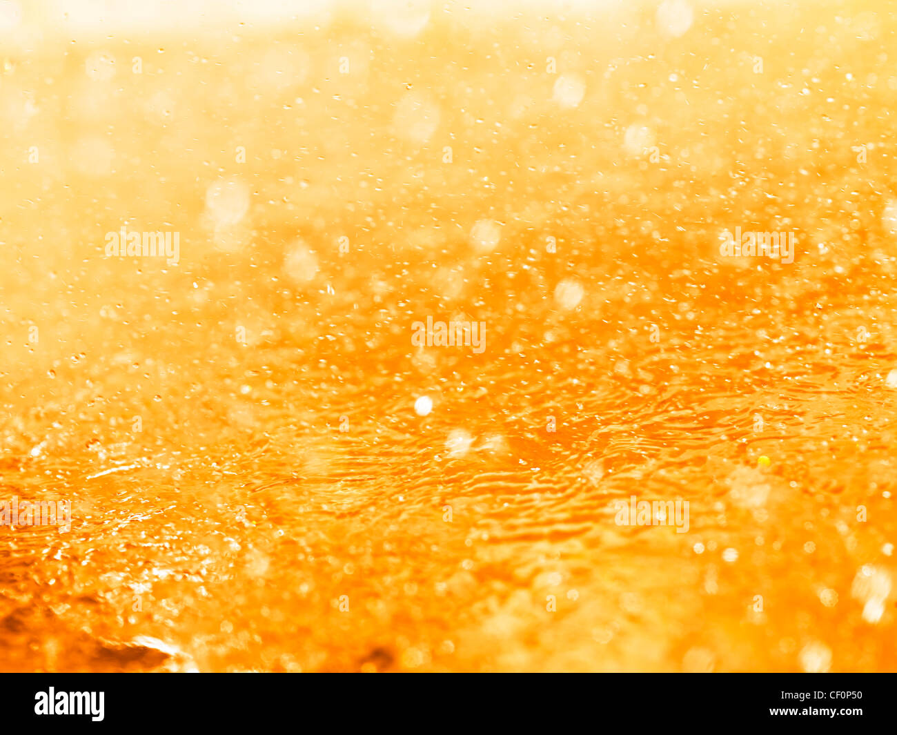 Orange splashing liquid closeup abstract background texture Stock Photo ...