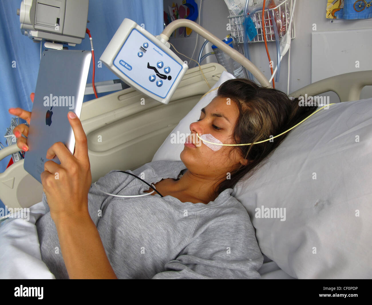 A young girl in hospital with anorexia using an iPad in the Royal ...