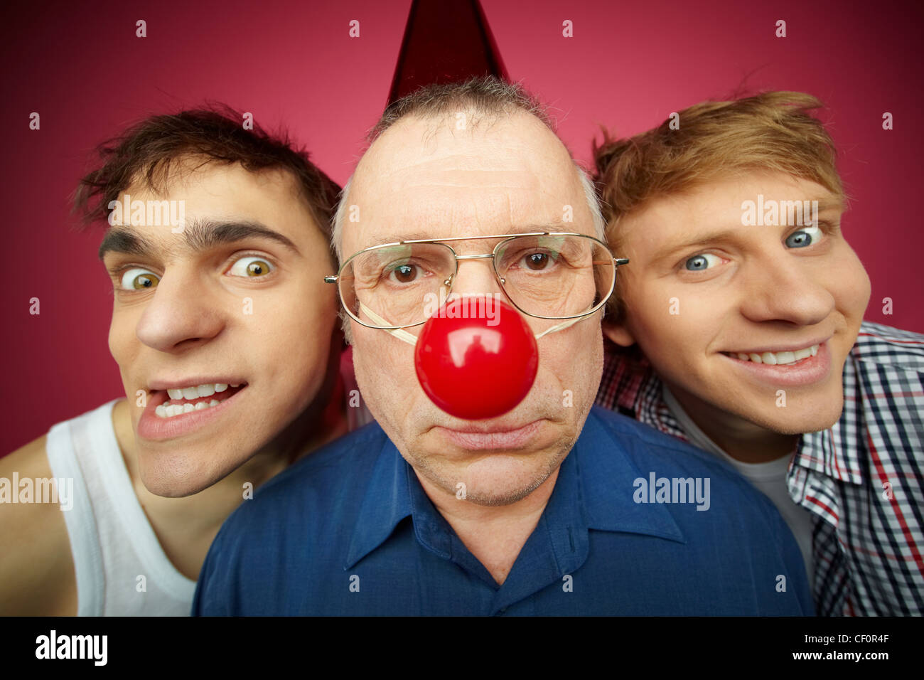 Three men of different age looking at camera, fool’s day celebration ...