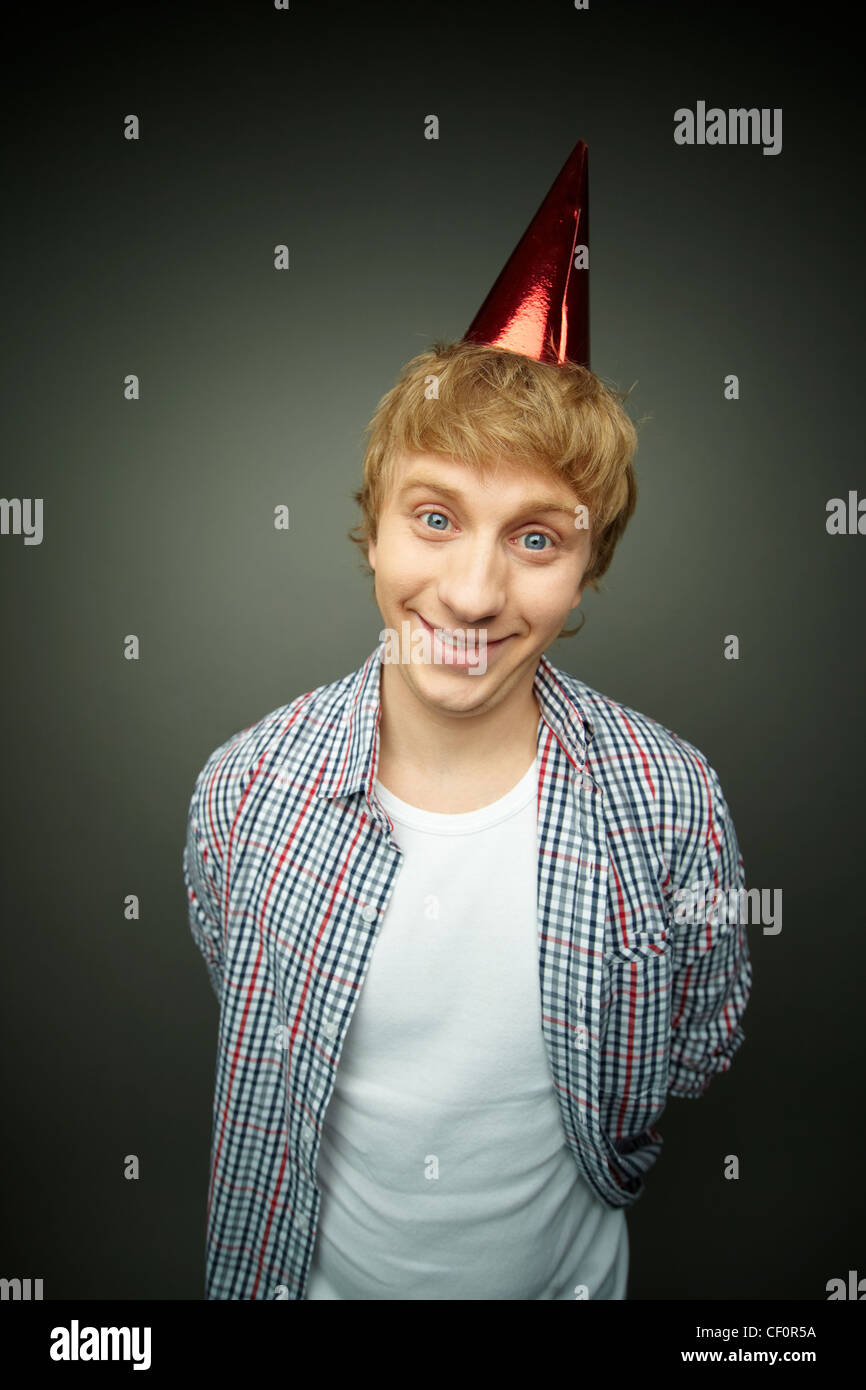 Cheerful guy in a cone cap being ready for fool’s day celebration Stock ...