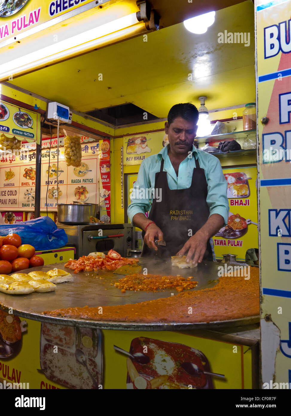 a chef cooking in a small carry-out shop in Juhu Beach, Mumbai ...
