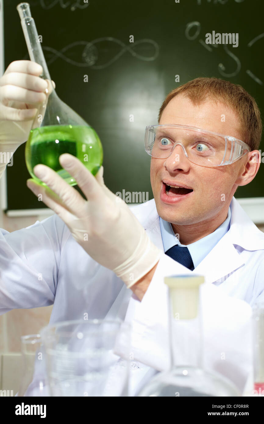 Handsome scientist looking beaker hi-res stock photography and images ...