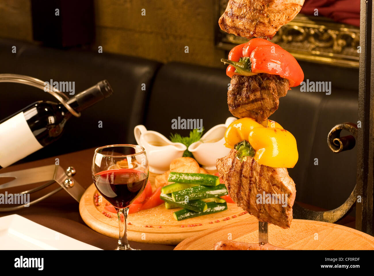 Big tasty roasted meat cuts at skewer on a decorated table Stock Photo ...