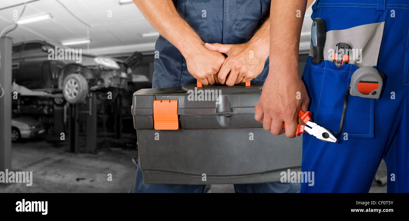 Auto mechanics closeup over workshop background Stock Photo - Alamy