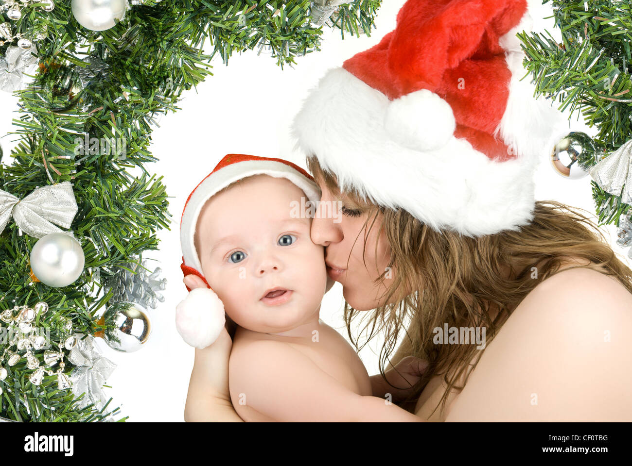 Beautiful mommy santa and her baby Santa boy on a white Stock Photo - Alamy