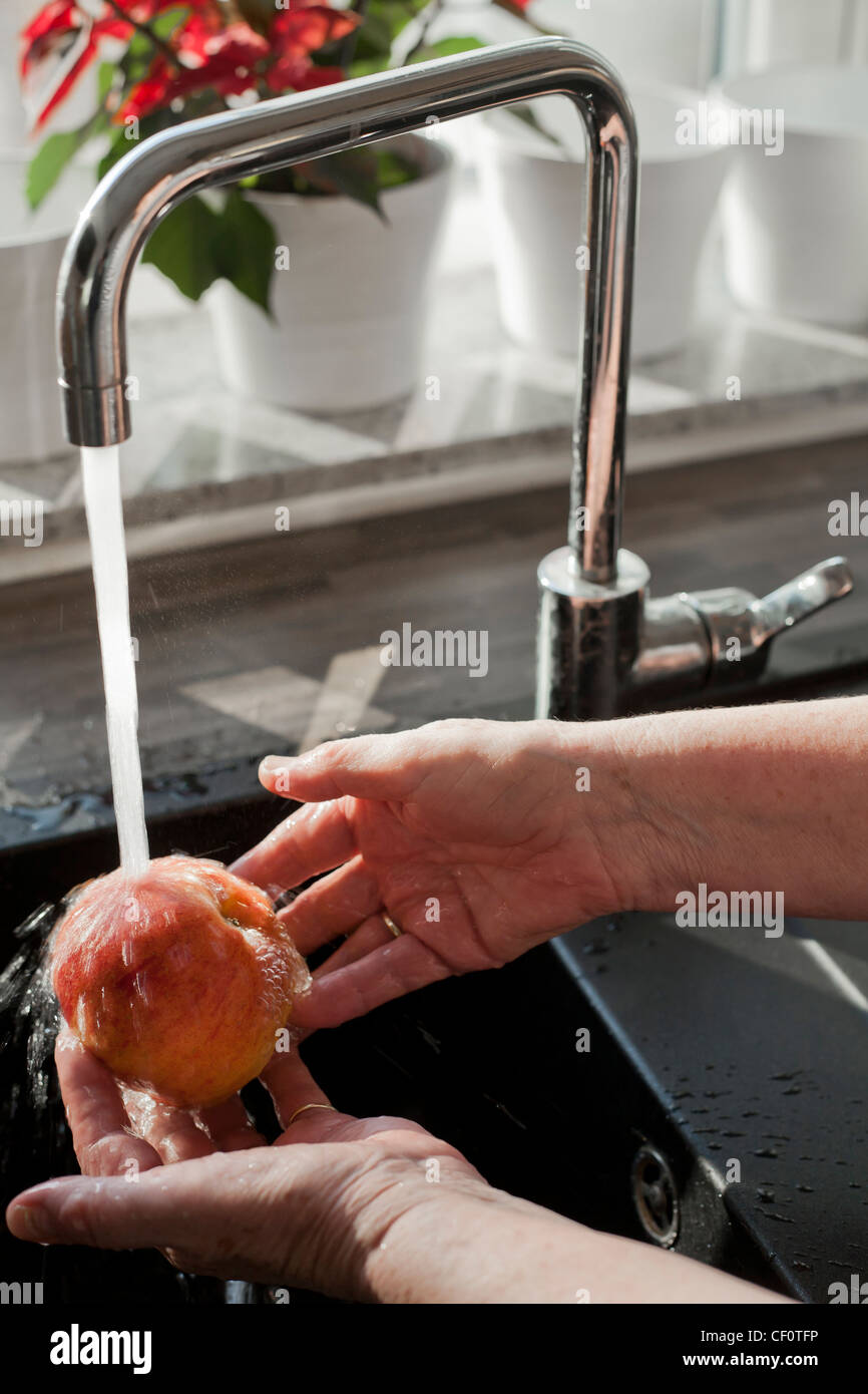 Female hands washing apple orange hi-res stock photography and images ...