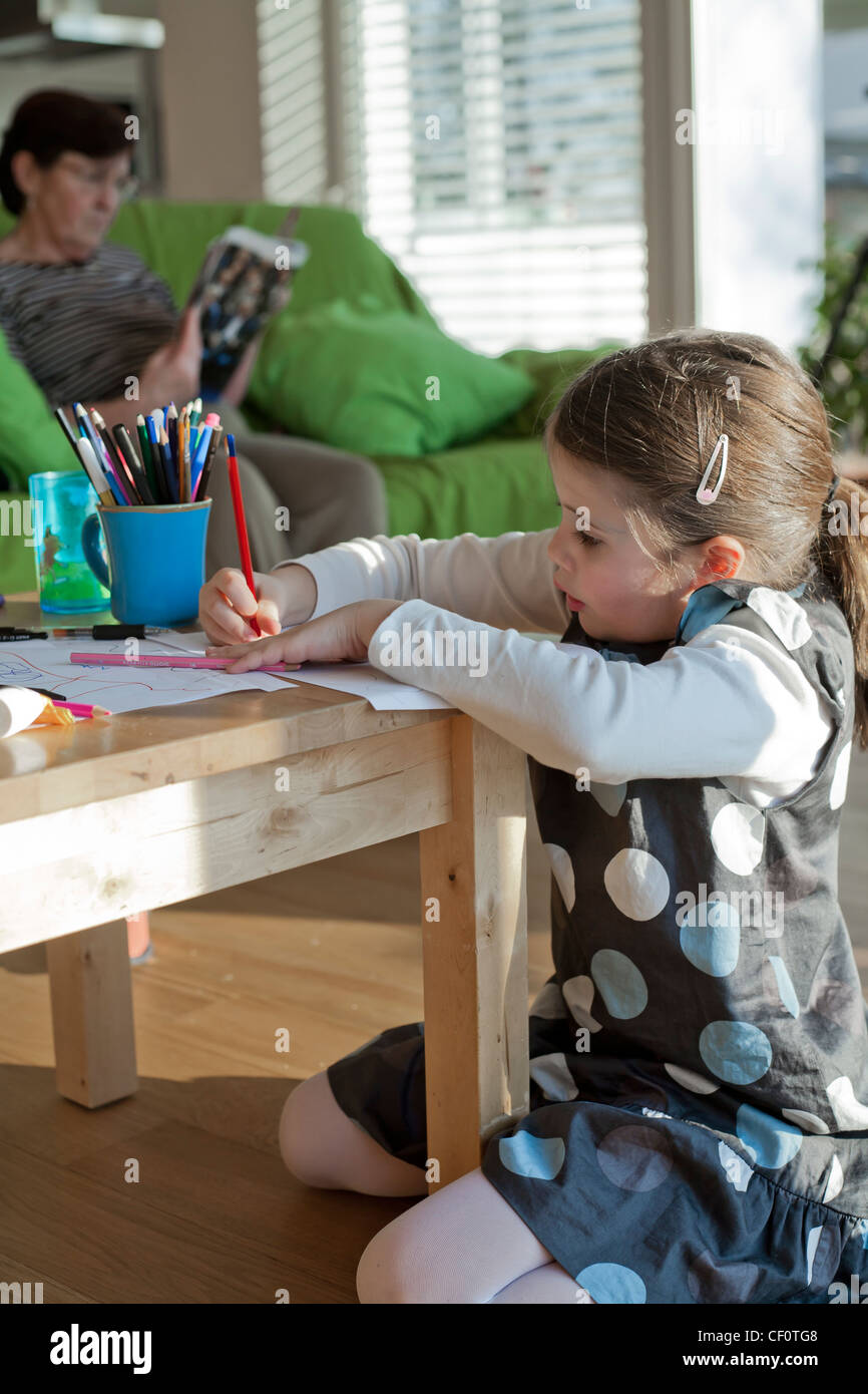 Girl drawing on paper Stock Photo - Alamy