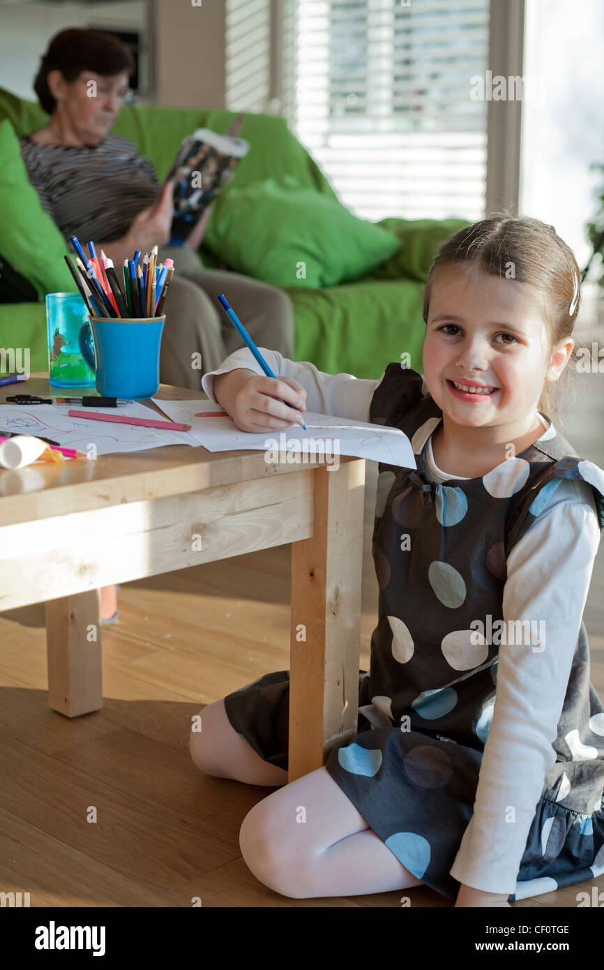 Girl drawing on paper Stock Photo - Alamy