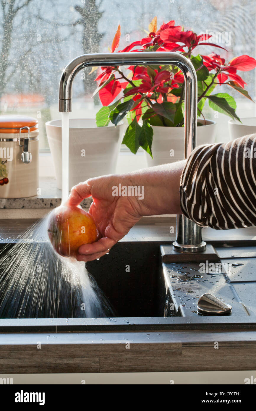 Female hands washing apple orange hi-res stock photography and images ...