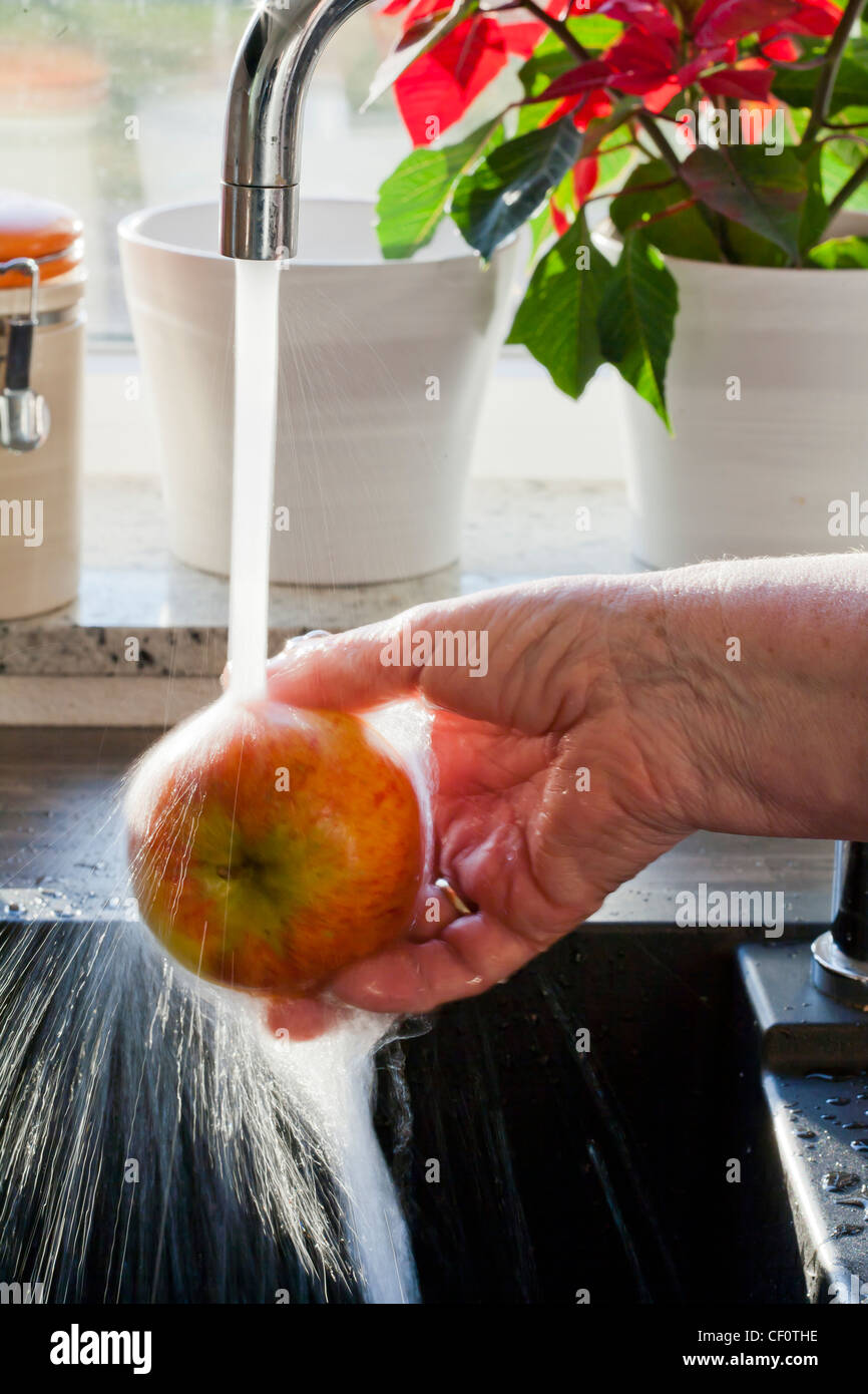 Female hands washing apple orange hi-res stock photography and images ...