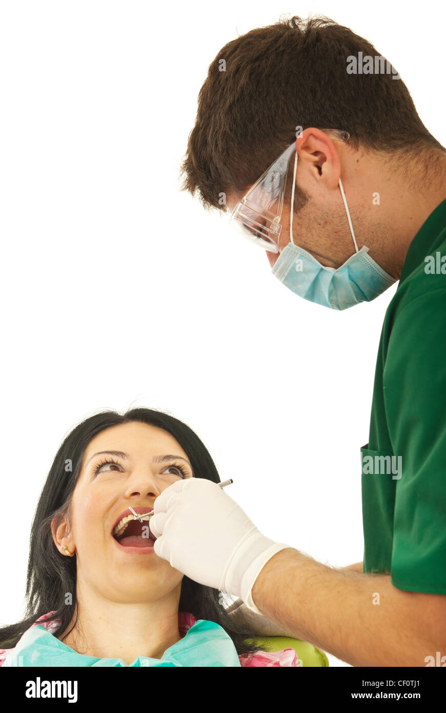 Dentist male with protective mask working with happy patient woman isolated on white background ...