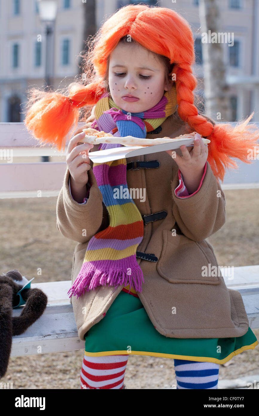 Little girl dressed in Pippi Long stocking eating pizza Stock Photo - Alamy