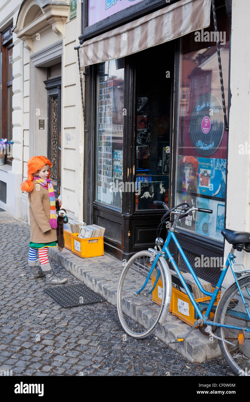 Curious girl looking into the shop window Stock Photo - Alamy