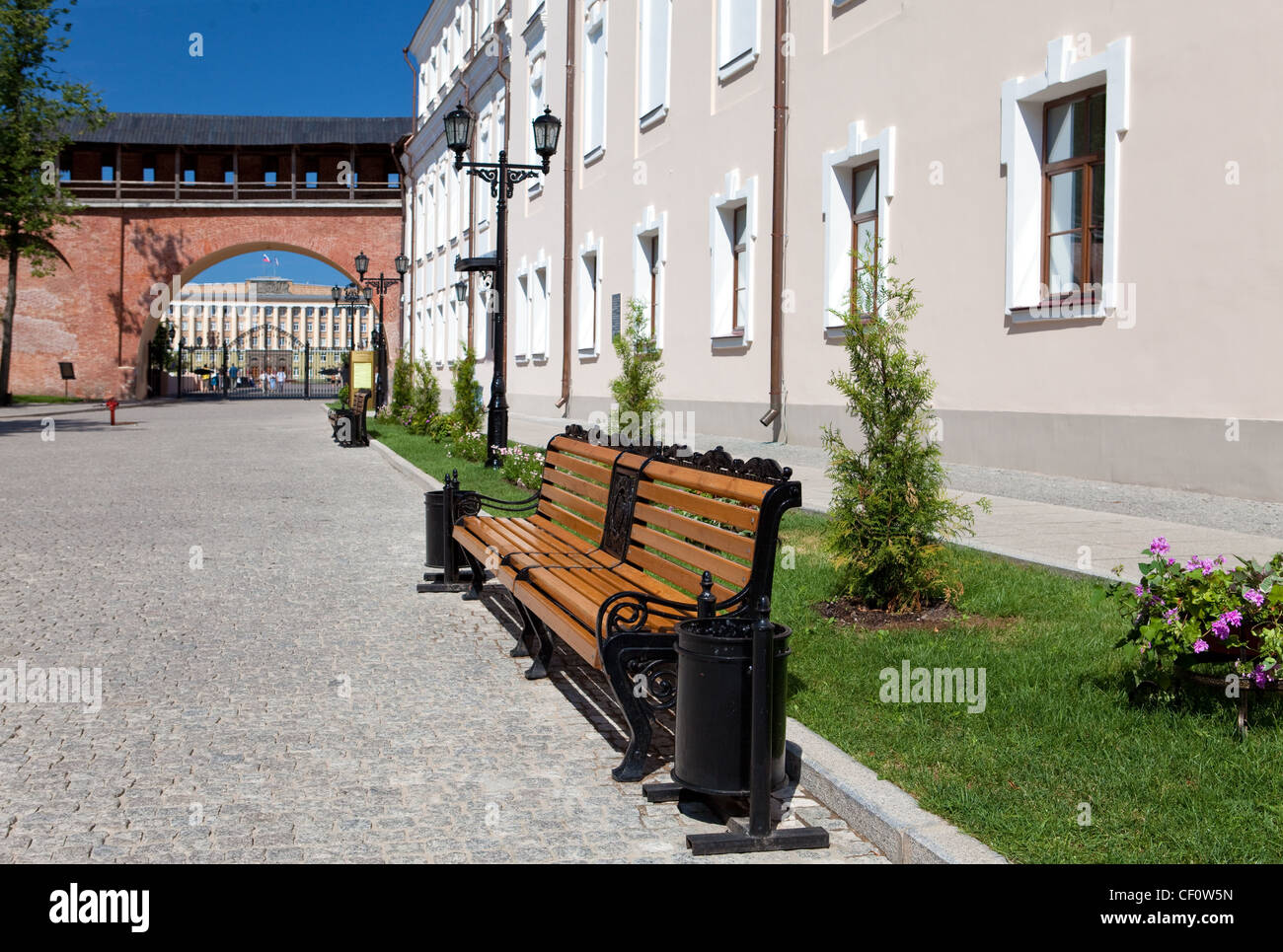 Bench in city street Stock Photo - Alamy
