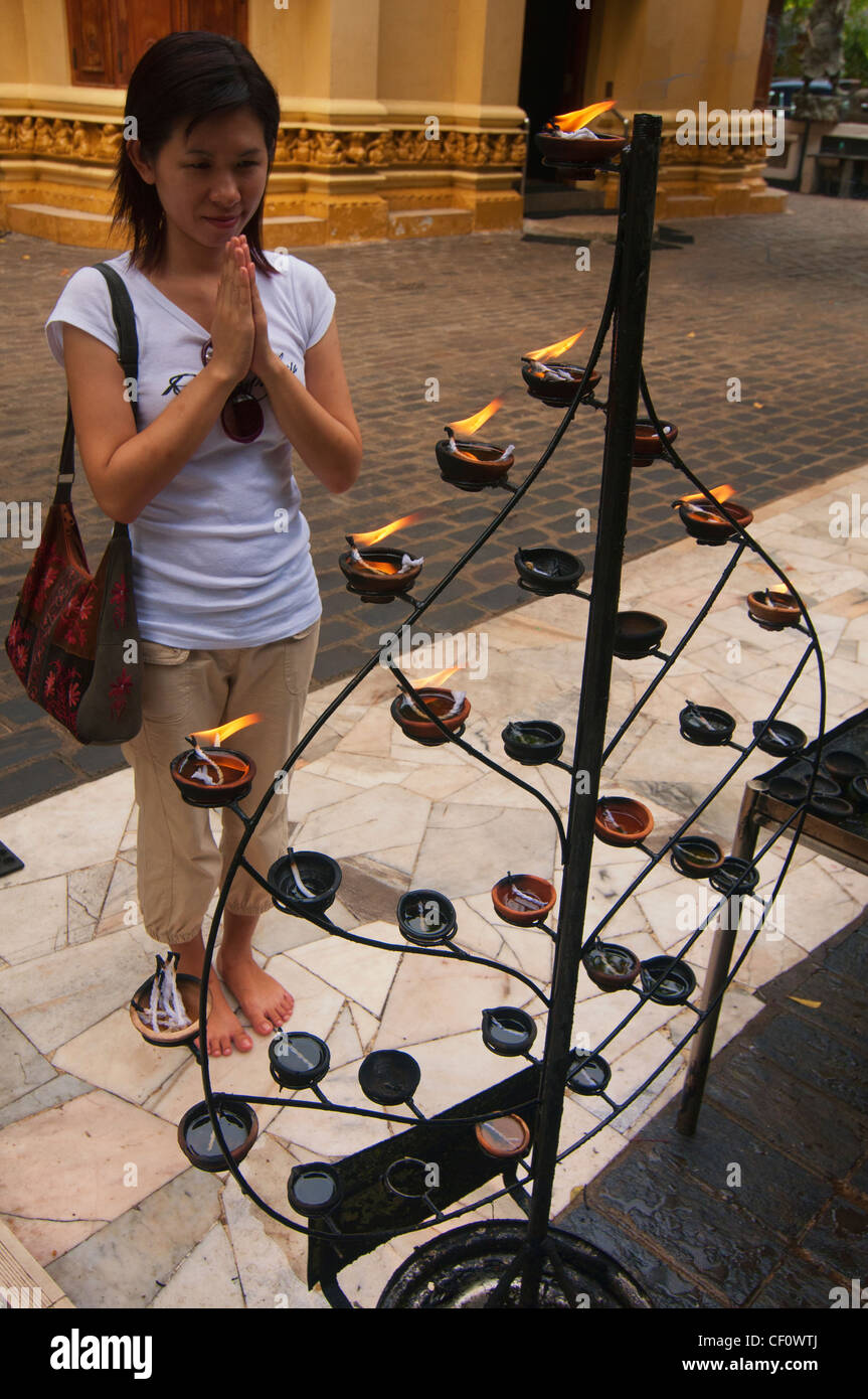 making merit at the Gangaramaya temple in Colombo, Sri Lanka Stock ...