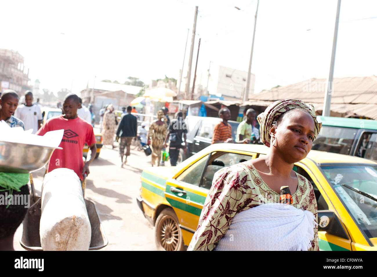African woman walks through busy market Stock Photo - Alamy