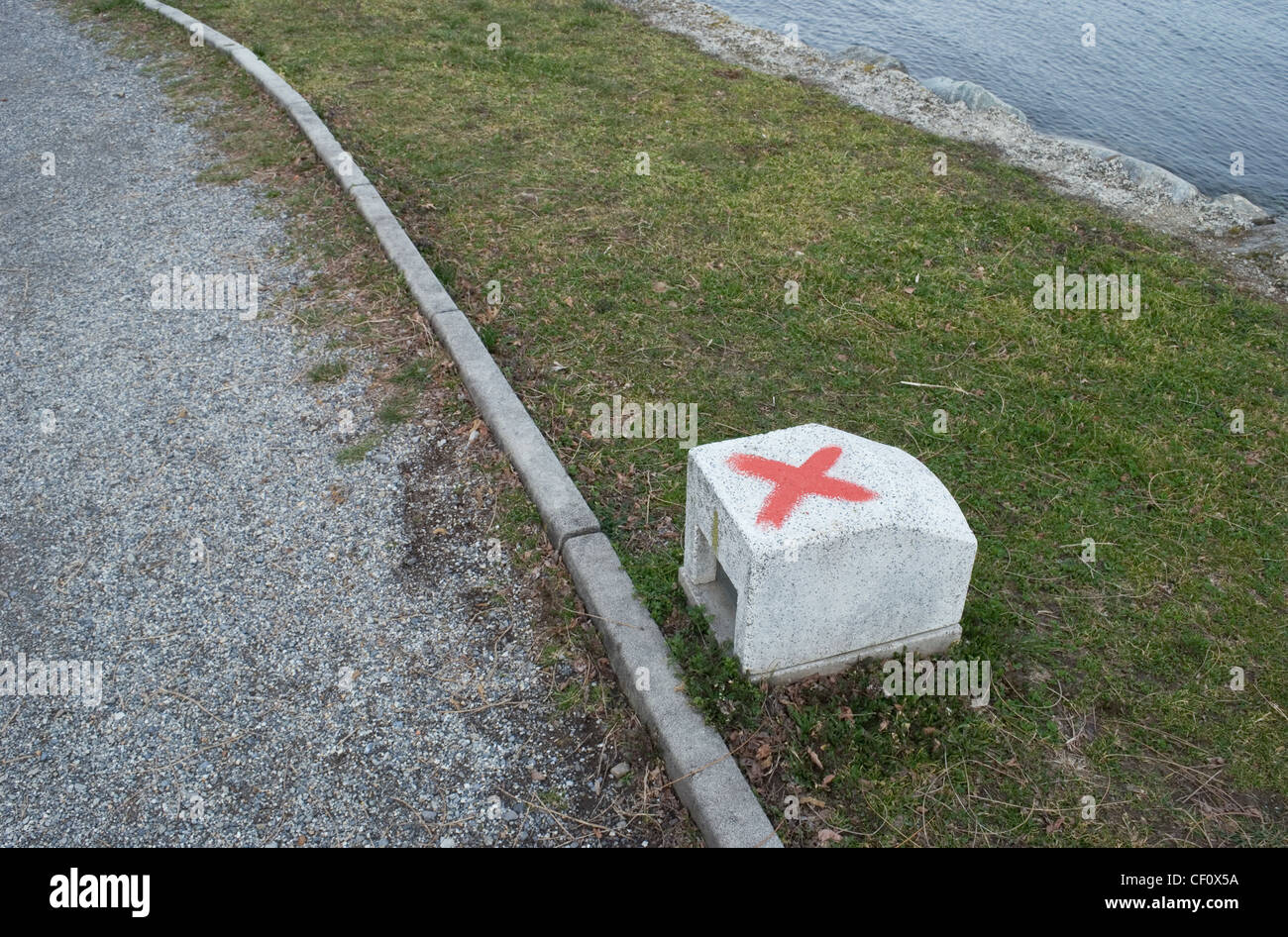 X sign on path stone Stock Photo - Alamy