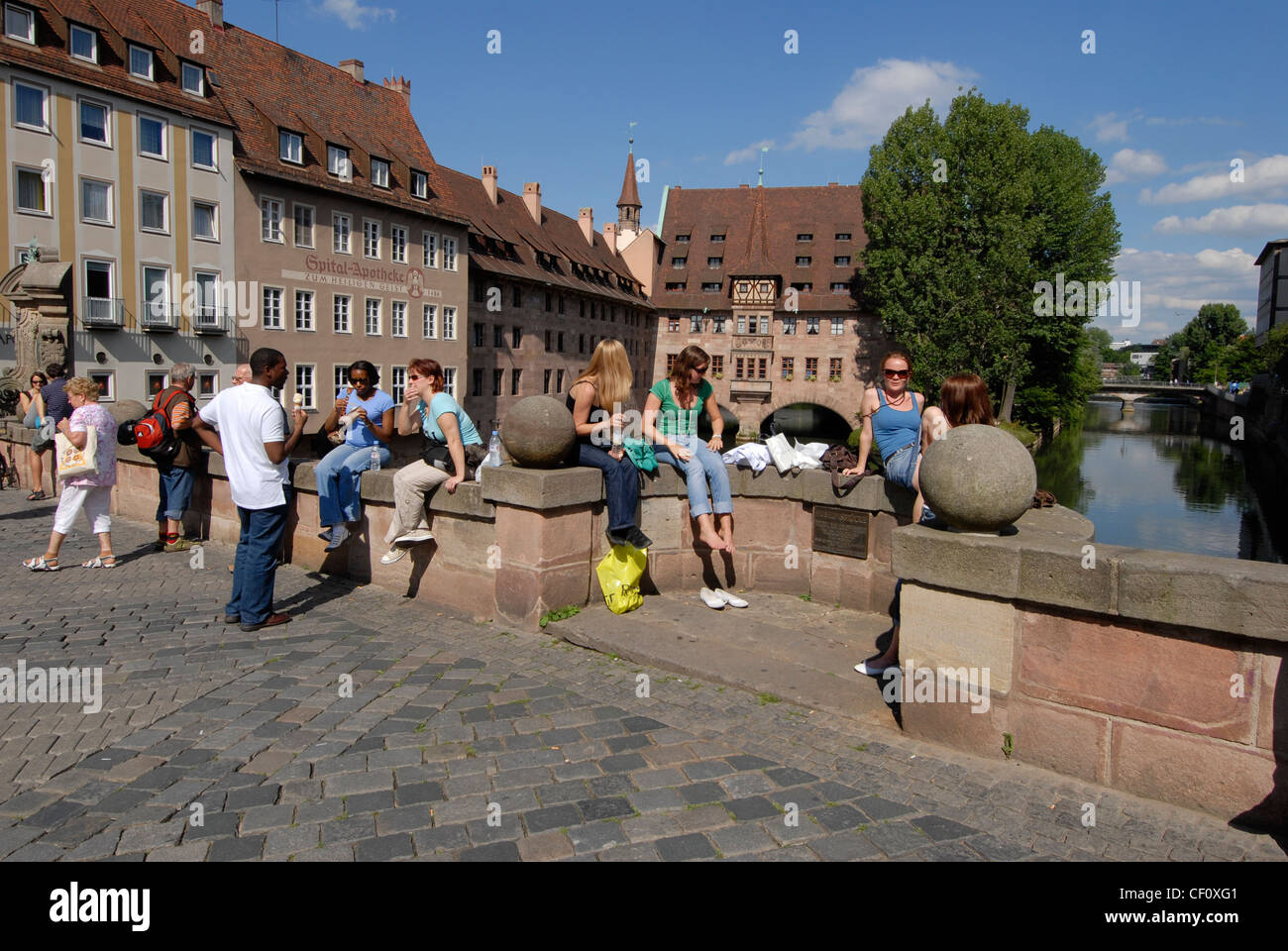a group of students bathing in the hot afternoon sun on Museum bridge ...