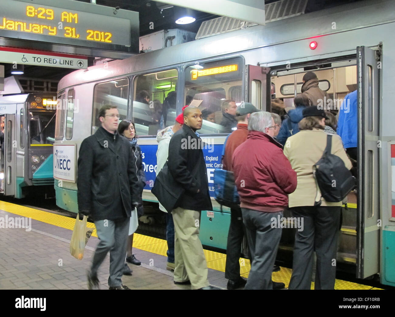 commuters boarding a greenline train in park street station in boston ...